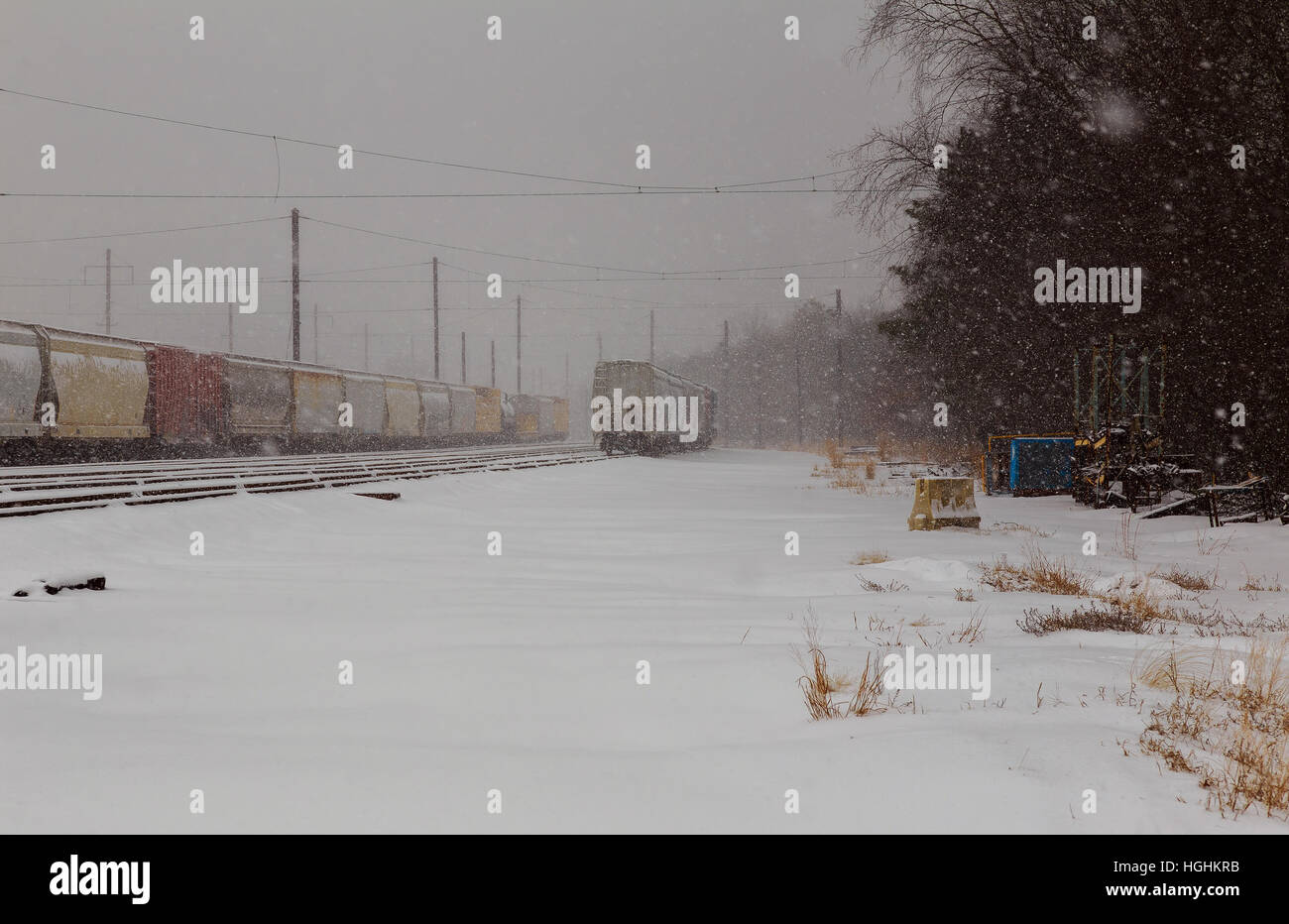 back view of a Freight train running on the railway tracks in winter ...