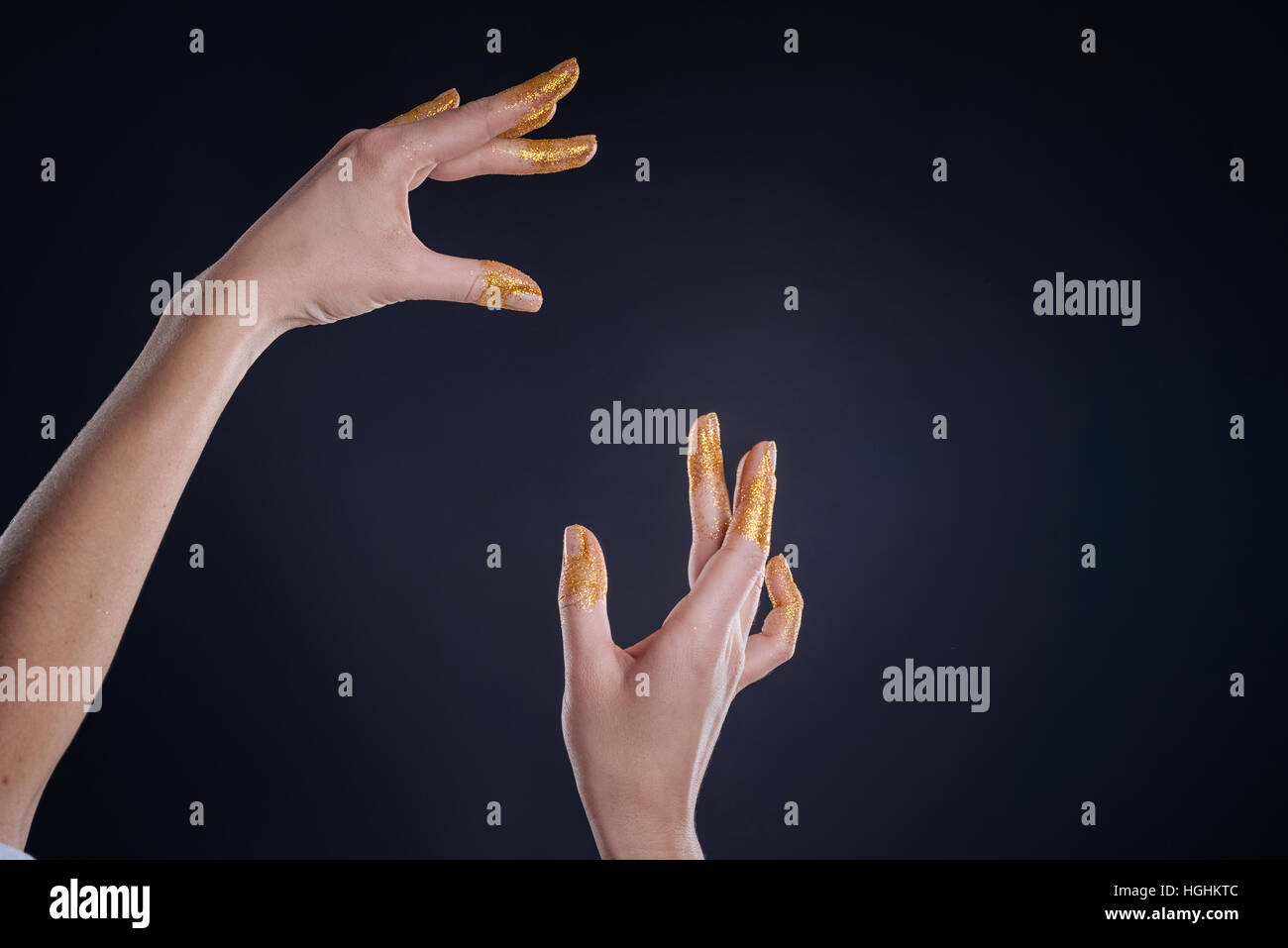 Slim hands posing on black background Stock Photo - Alamy
