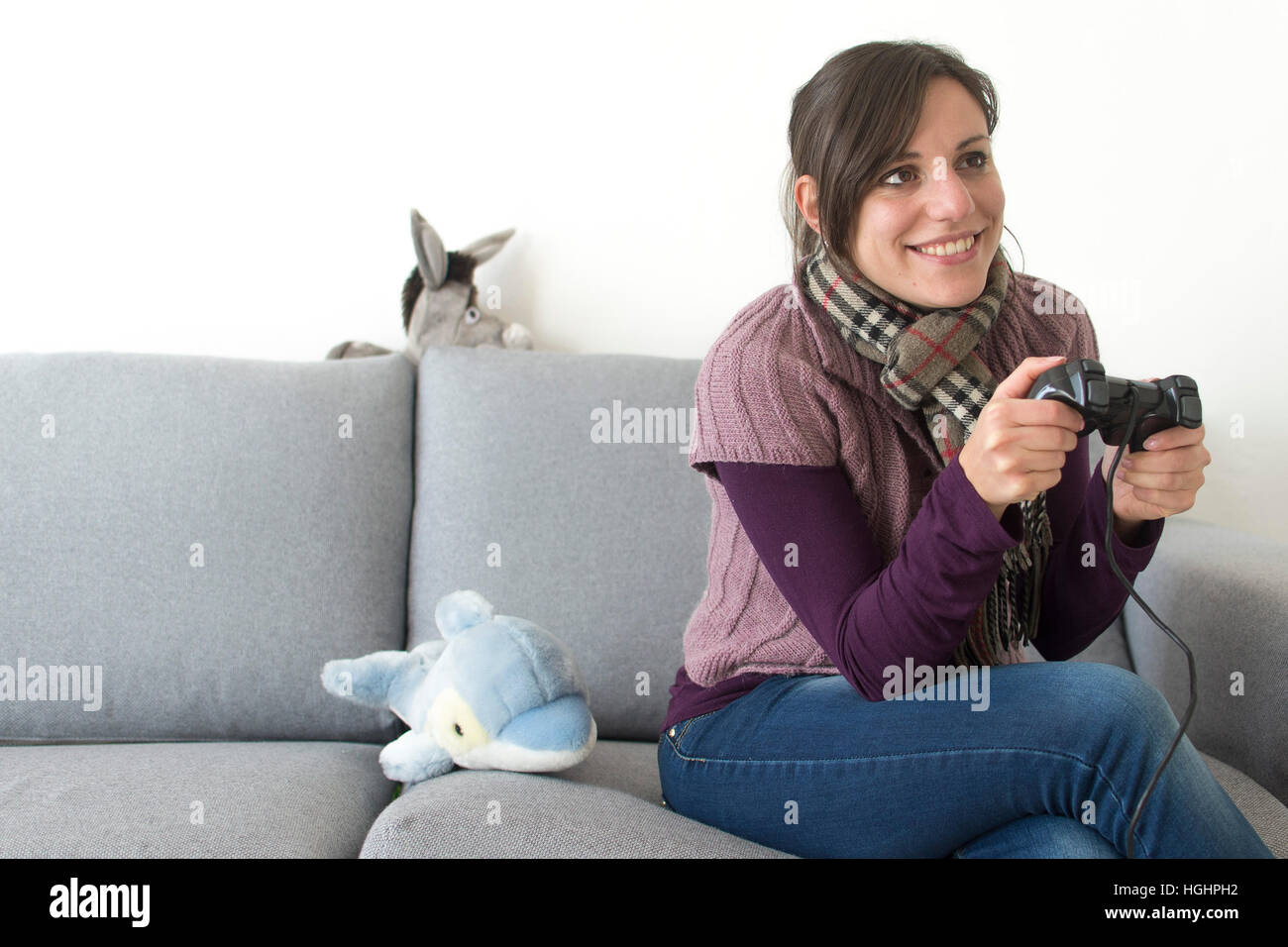 Pretty girl playing videogames at home Stock Photo - Alamy
