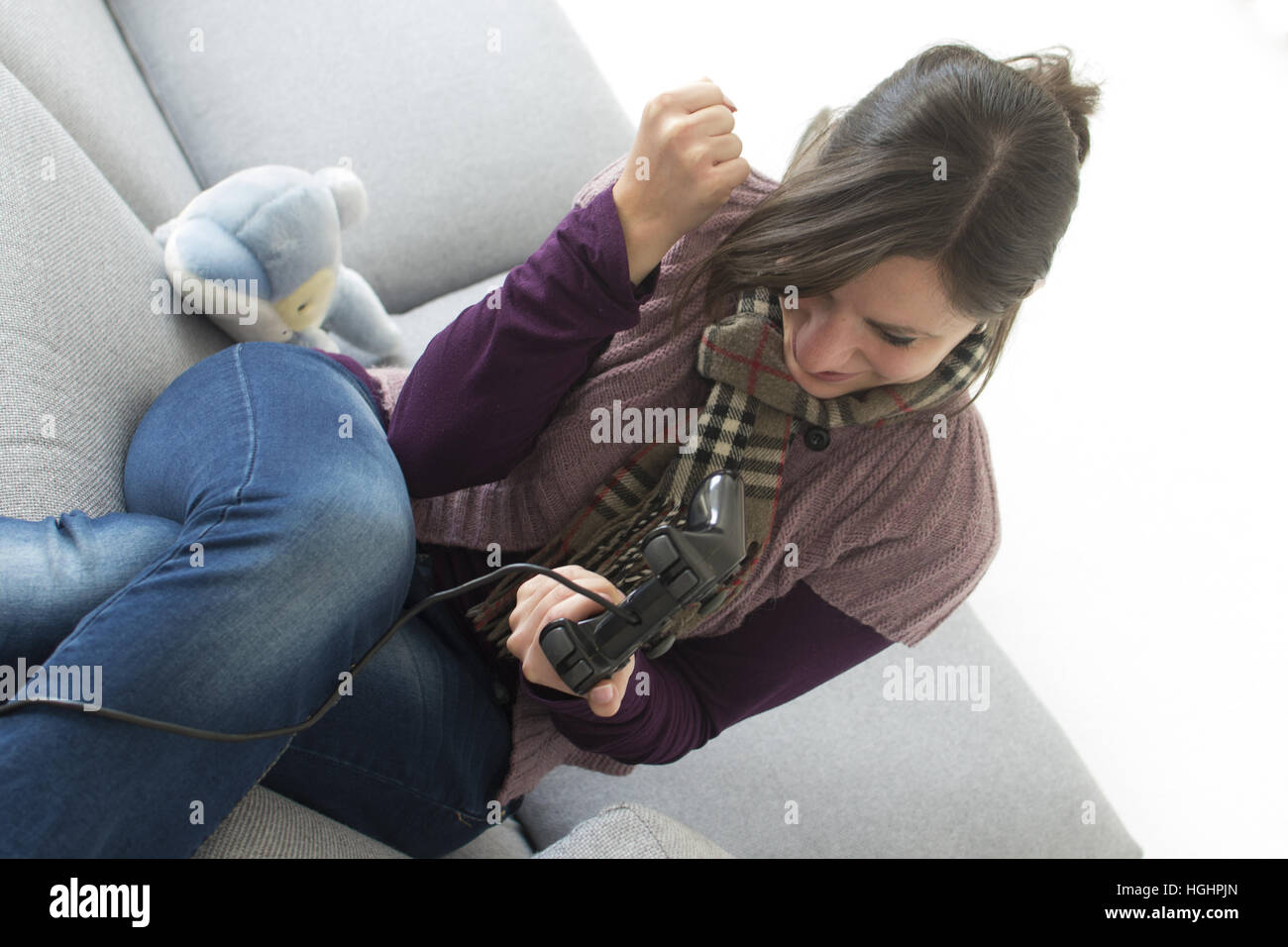 Pretty girl playing videogames at home Stock Photo - Alamy