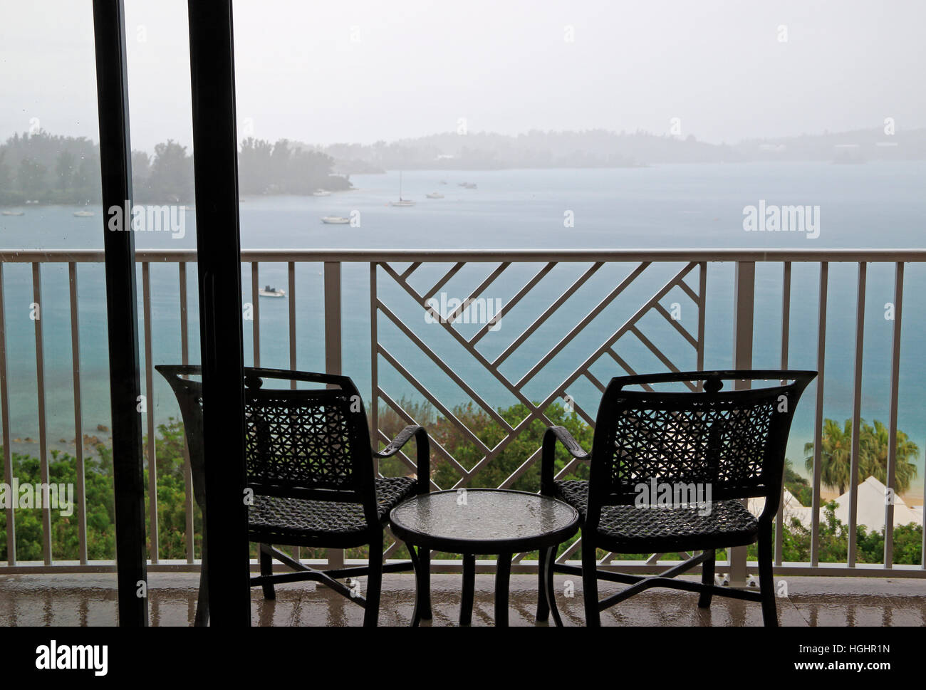 Looking out of balcony, Grotto Bay in Bermuda is under rain and fog ...