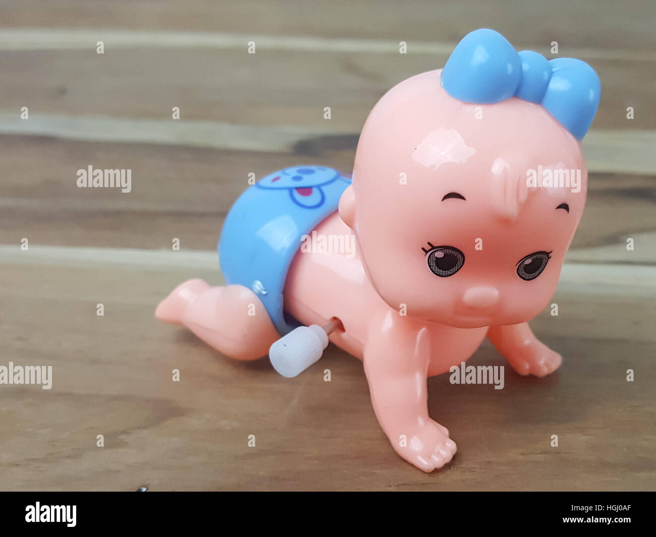 Mechanical wind up crawling baby toy on wood background Stock Photo - Alamy