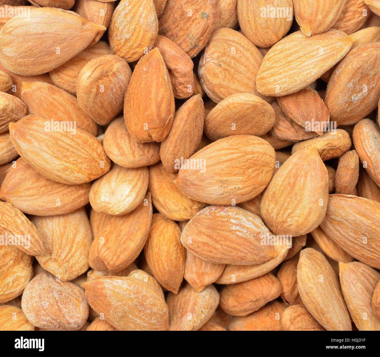 Almonds close-up background Stock Photo - Alamy