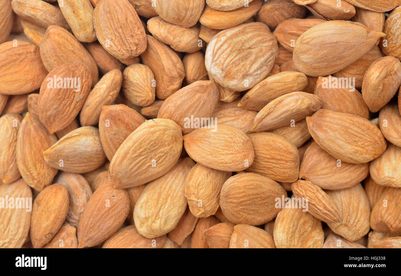 Almonds close-up background Stock Photo - Alamy