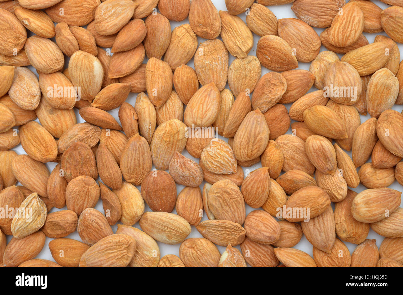 Almonds close-up background Stock Photo - Alamy