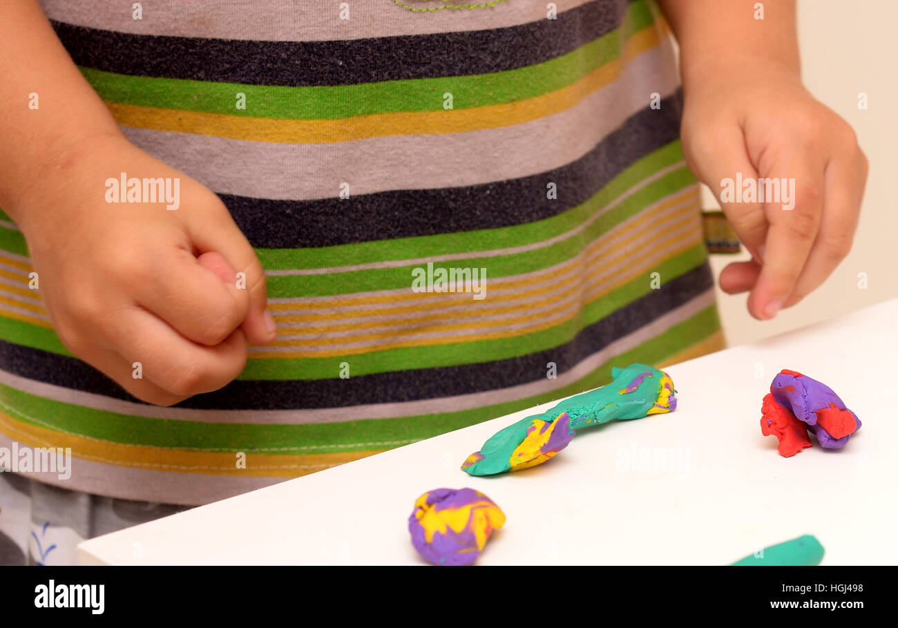 little boy playing with clay dough, education and daycare concept Stock ...