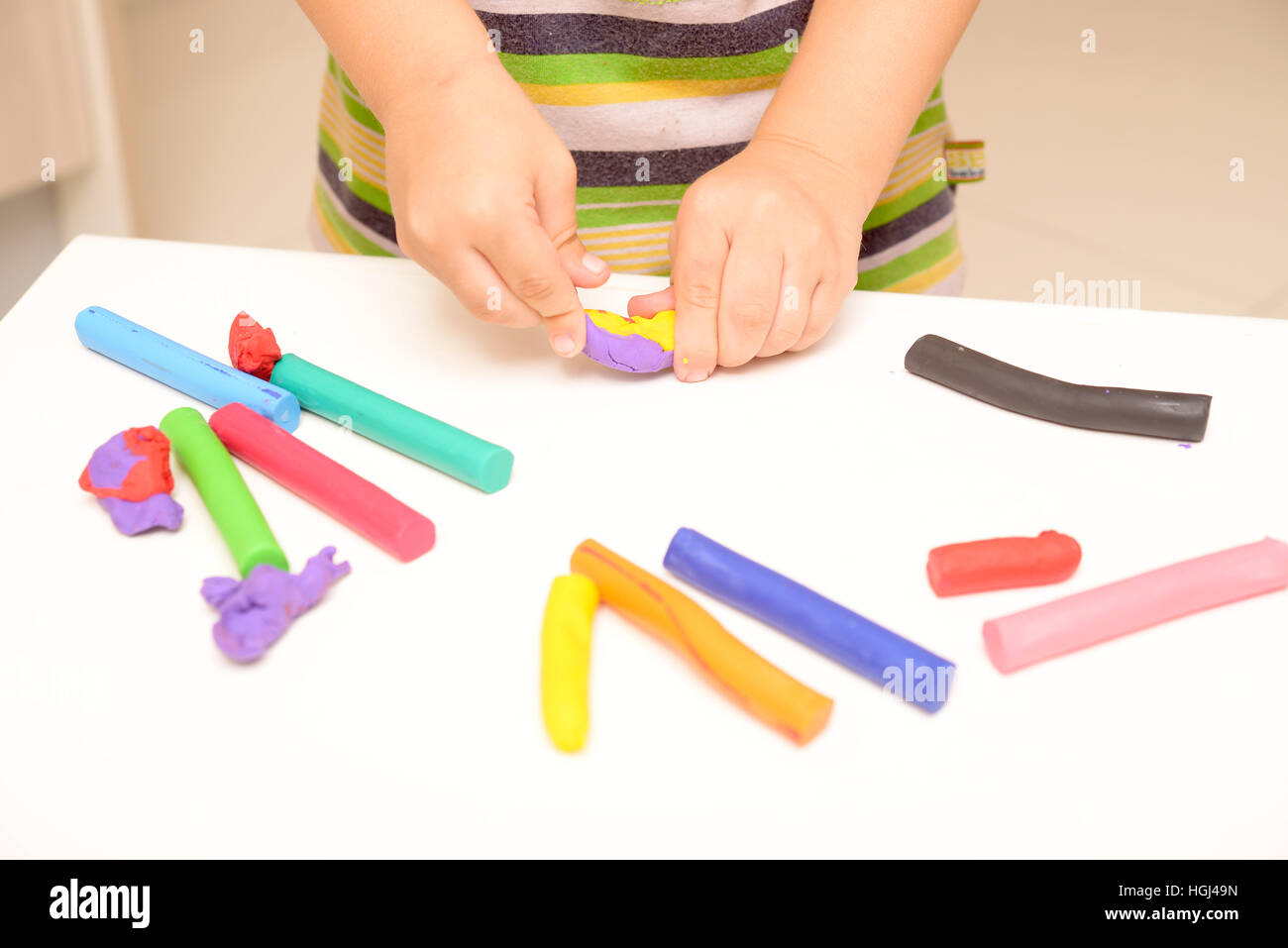 little boy playing with clay dough, education and daycare concept Stock ...