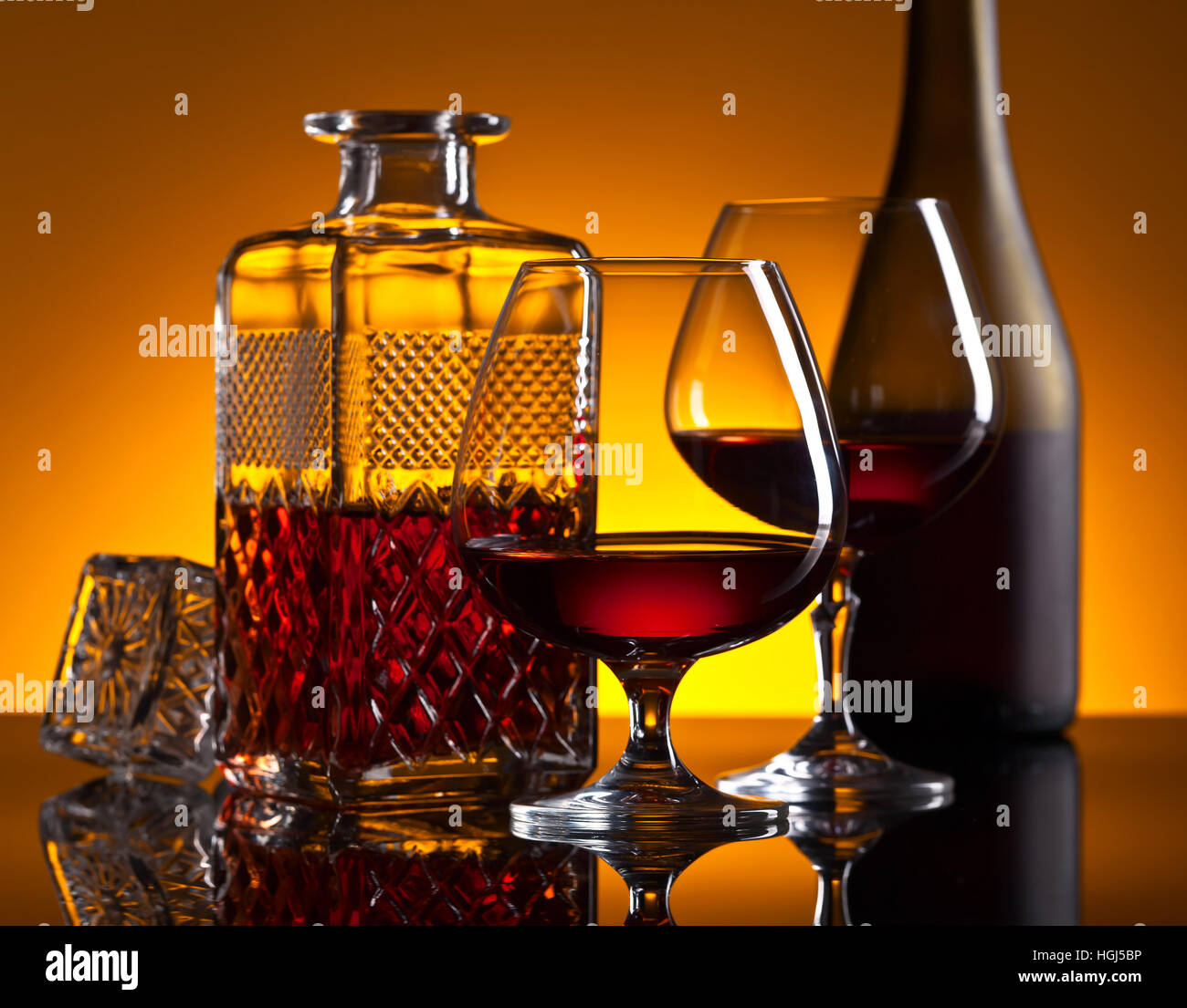 Two glasses of brandy on the reflective background Stock Photo - Alamy