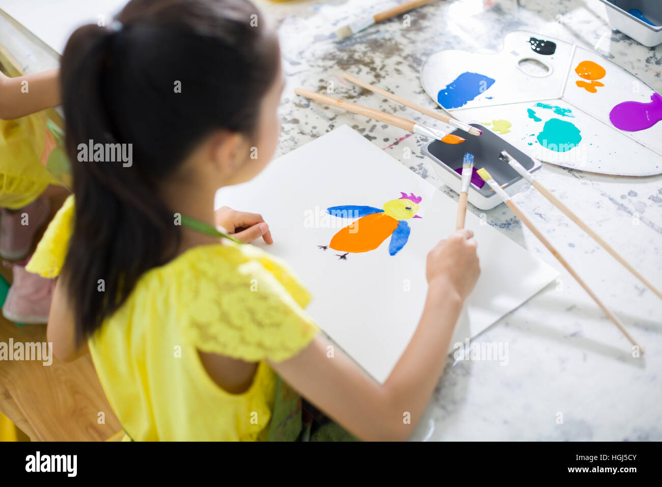 Little girl painting in art class Stock Photo - Alamy