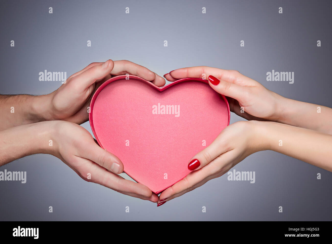 Hands giving and receiving a present Stock Photo - Alamy