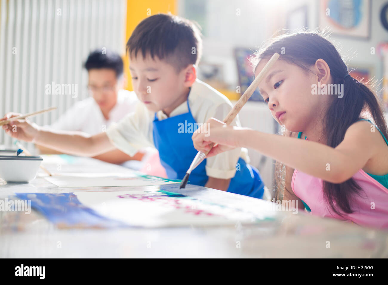 Little children painting in art class Stock Photo - Alamy
