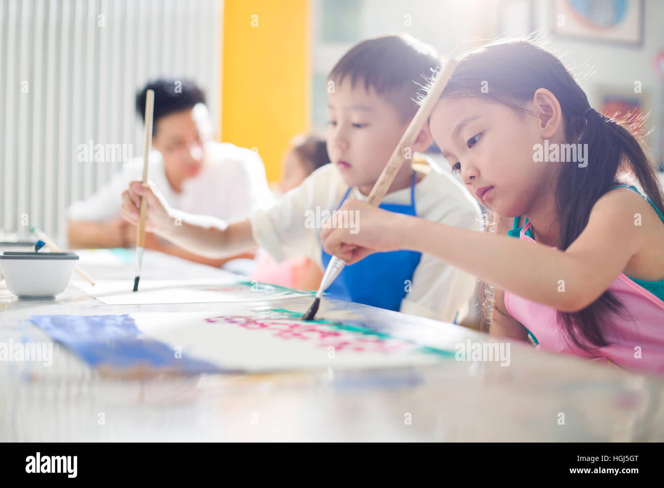 Little children painting in art class Stock Photo - Alamy