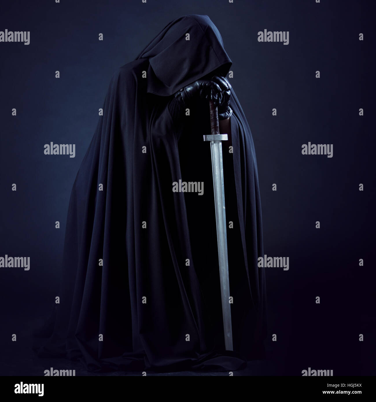 Portrait of a courageous warrior wanderer in a black cloak and sword in ...
