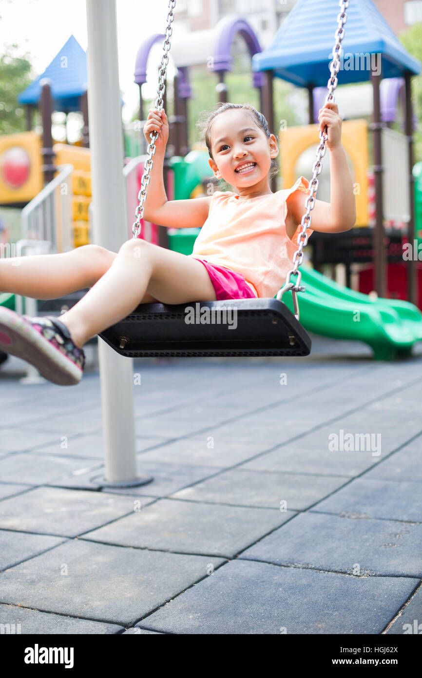 Happy girl on swing Stock Photo - Alamy