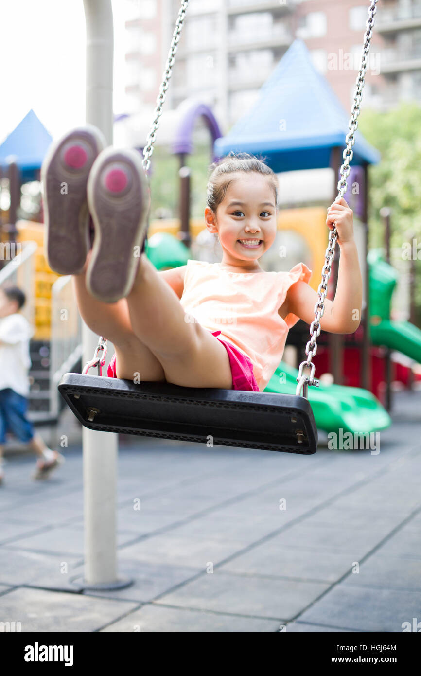 Happy girl on swing Stock Photo - Alamy