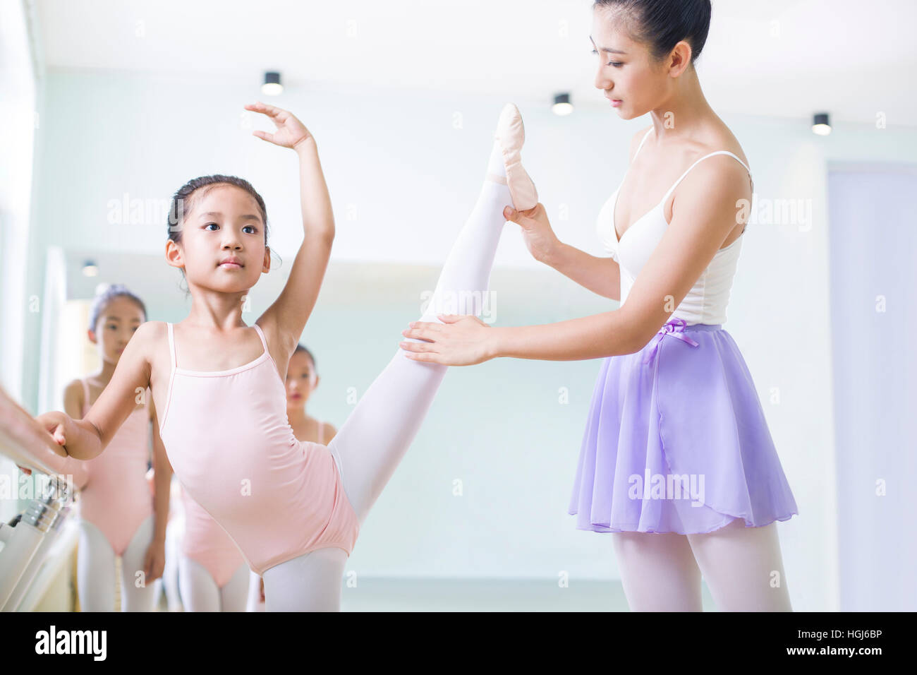 Young ballet instructor teaching girl in ballet studio Stock Photo - Alamy