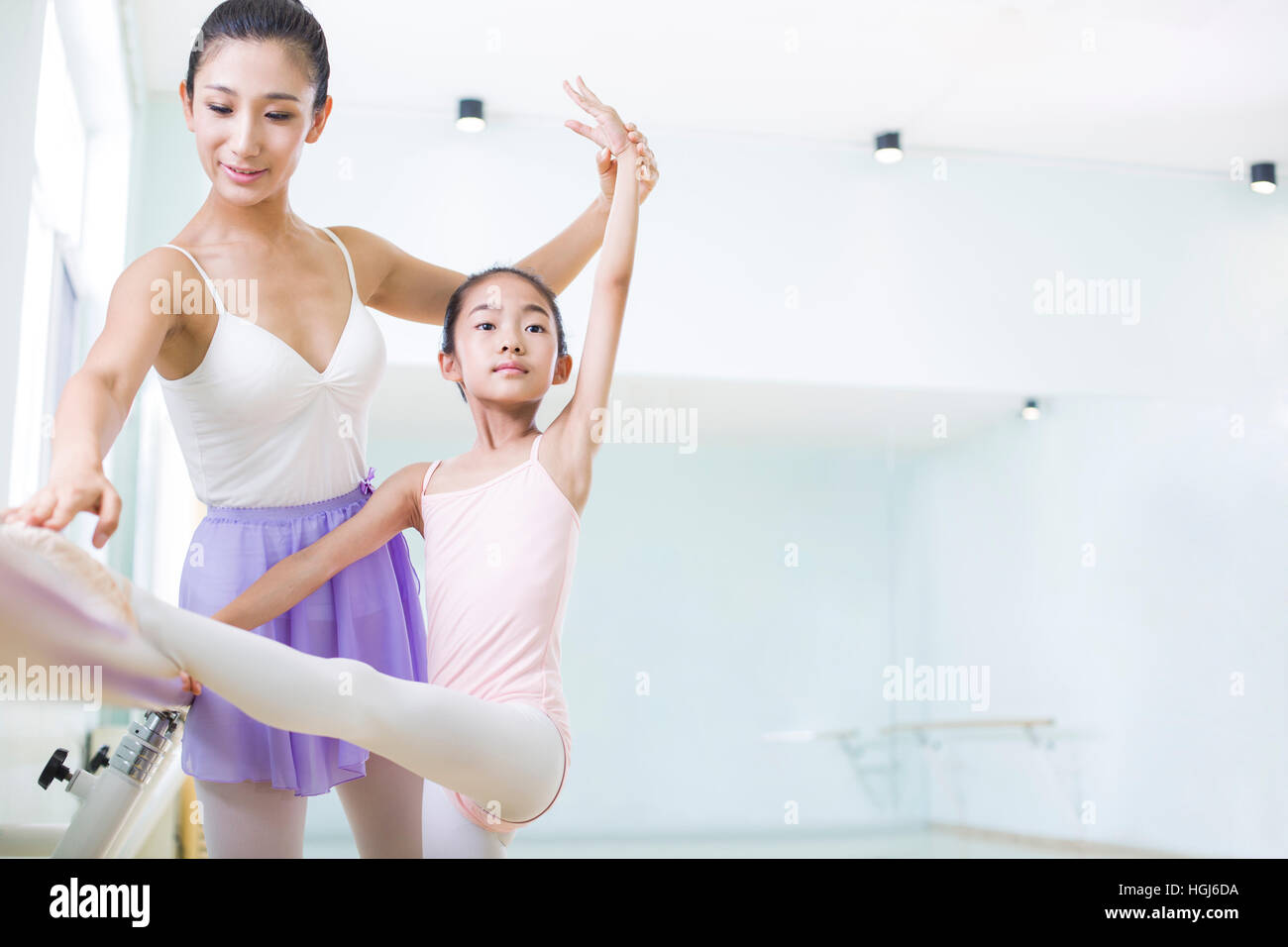 Young ballet instructor teaching girl in ballet studio Stock Photo - Alamy