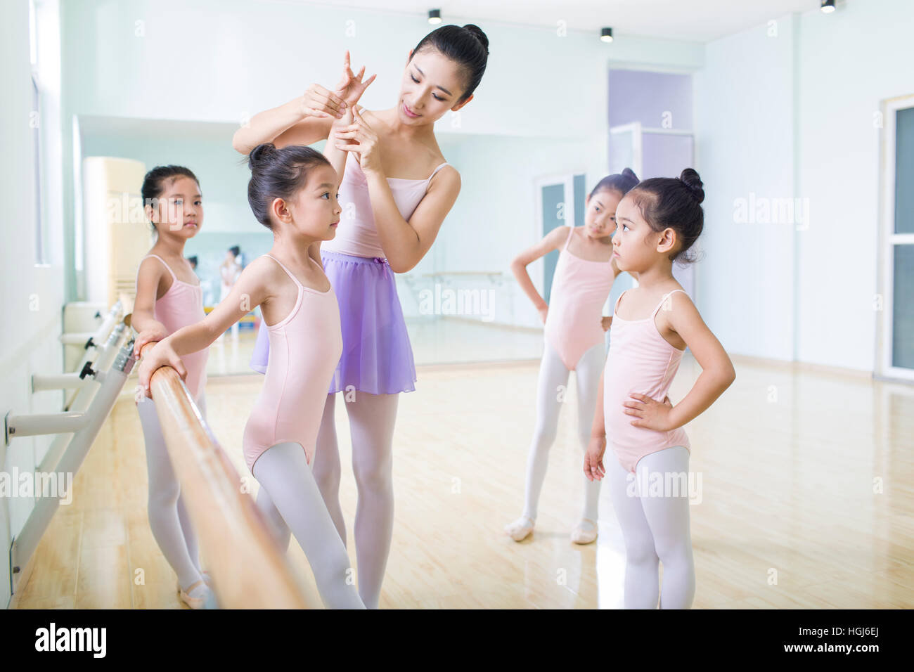 Young ballet instructor teaching girls in ballet studio Stock Photo - Alamy
