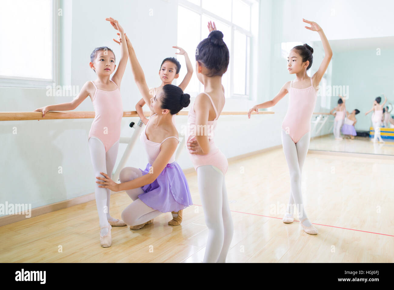 Young ballet instructor teaching girls in ballet studio Stock Photo - Alamy