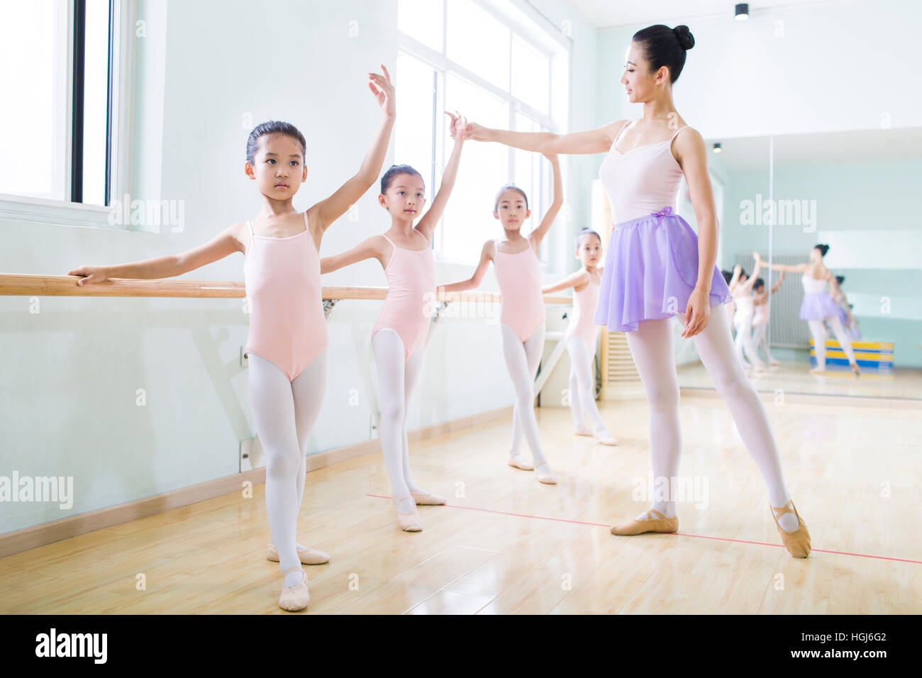 Young ballet instructor teaching girls in ballet studio Stock Photo - Alamy