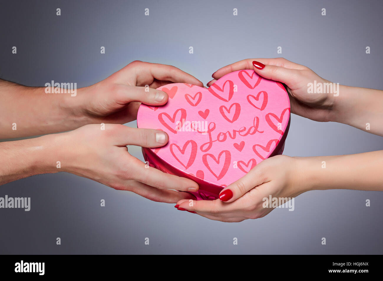 Hands giving and receiving a present Stock Photo - Alamy