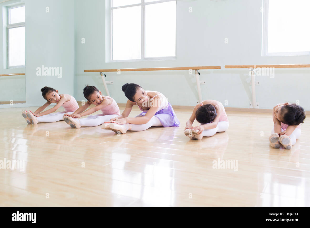 Young ballet instructor teaching girls in ballet studio Stock Photo - Alamy