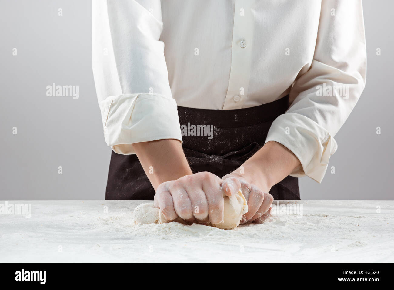 Hands kneading a dough Stock Photo - Alamy