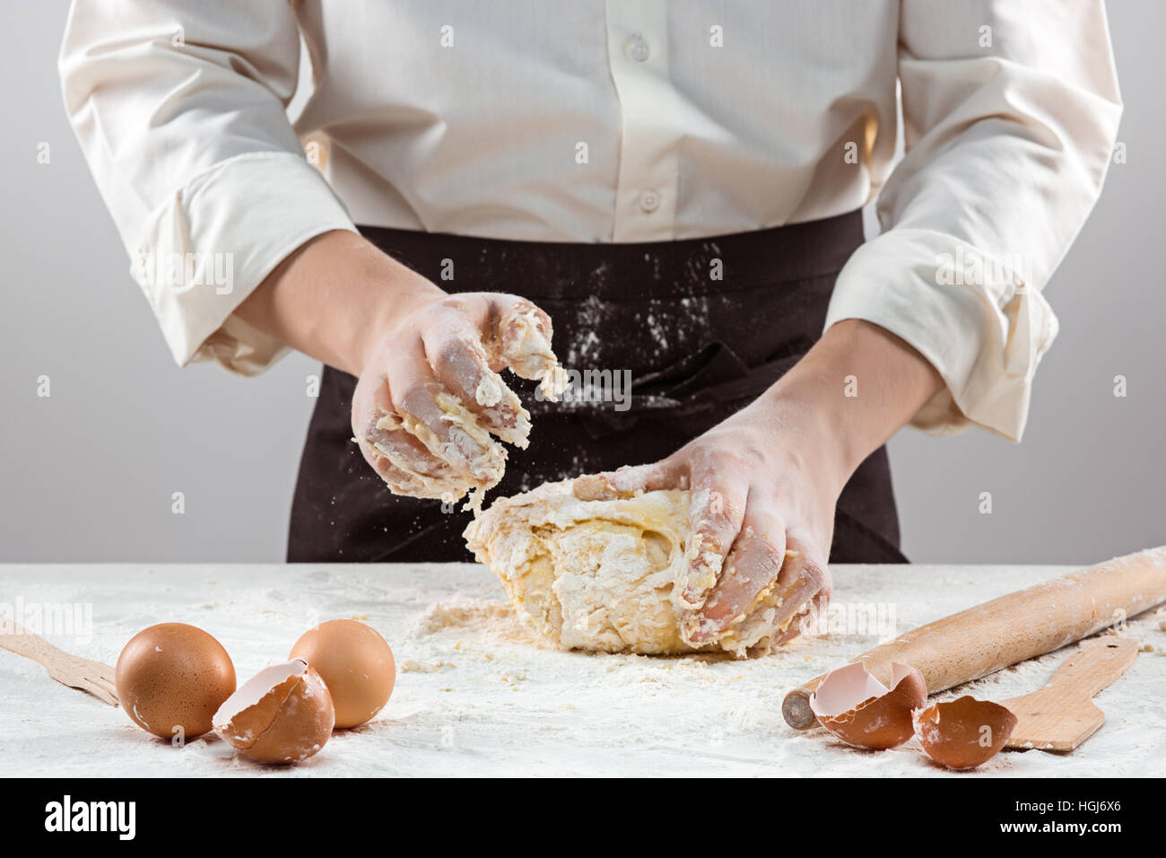 Hands kneading a dough Stock Photo - Alamy