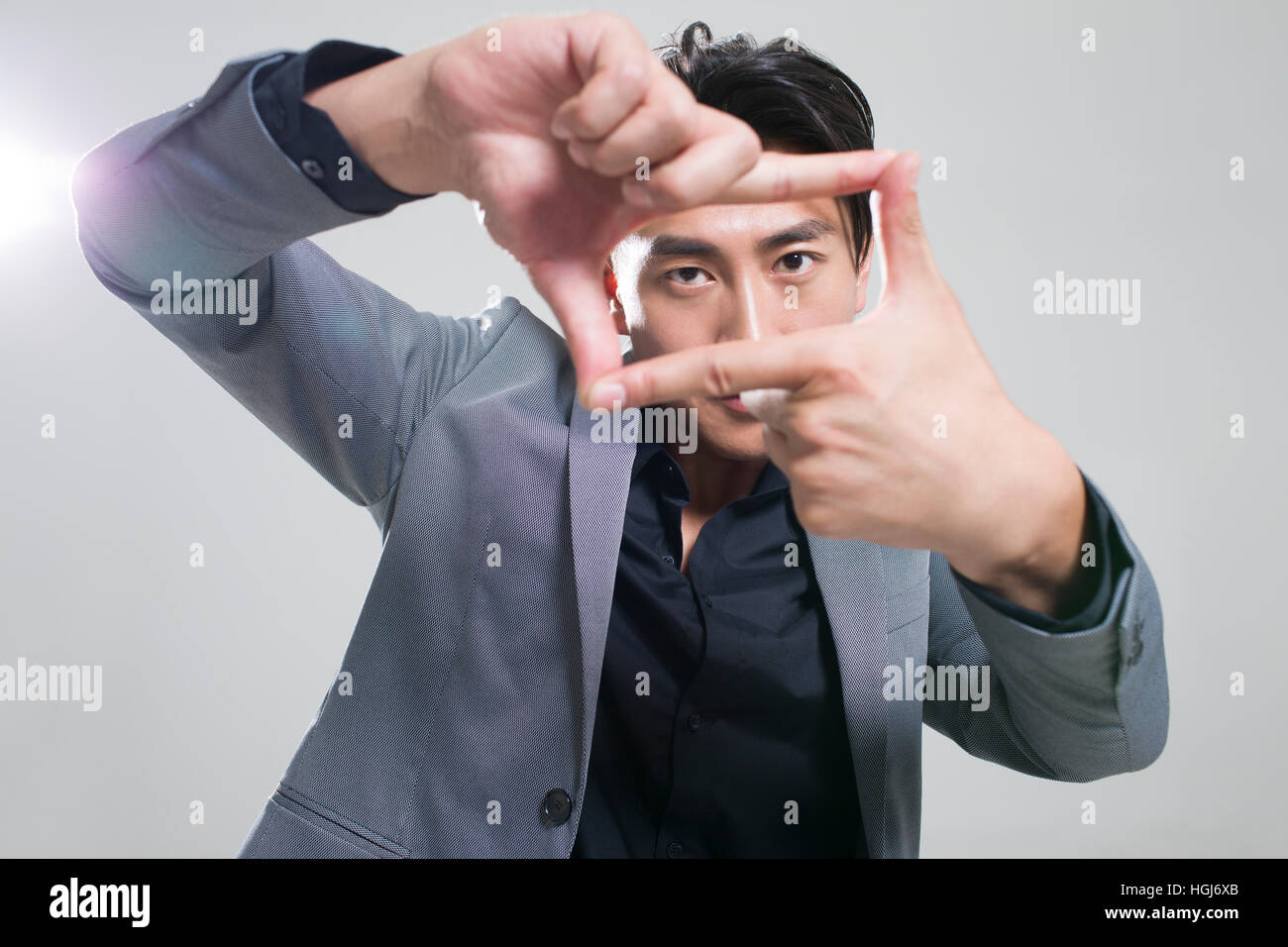 Young man making finger frame Stock Photo - Alamy