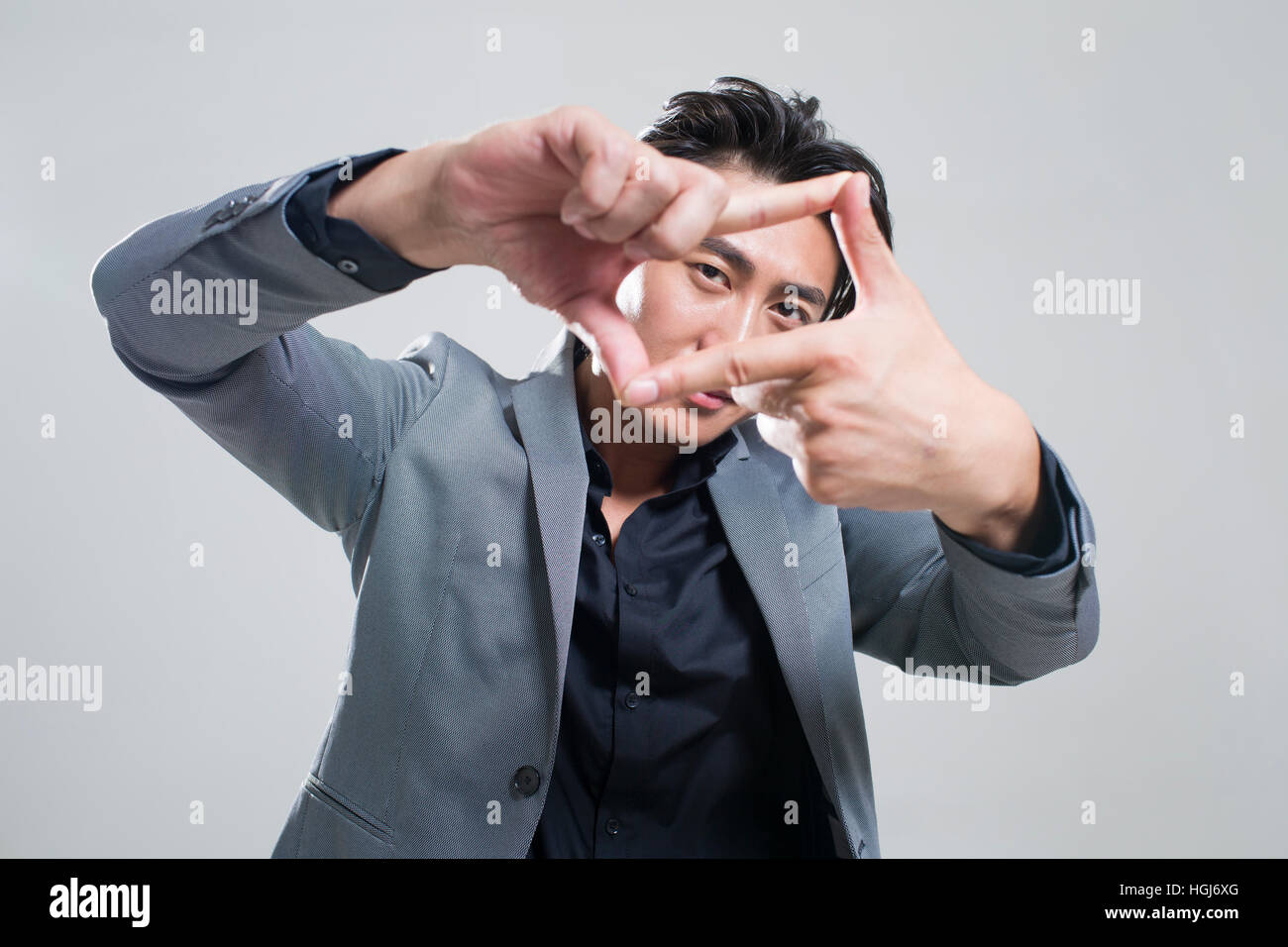 Young man making finger frame Stock Photo - Alamy