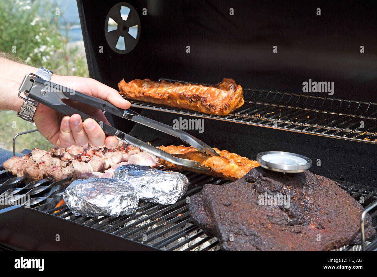 Grilled food on a barbeque grill outdoor Stock Photo - Alamy
