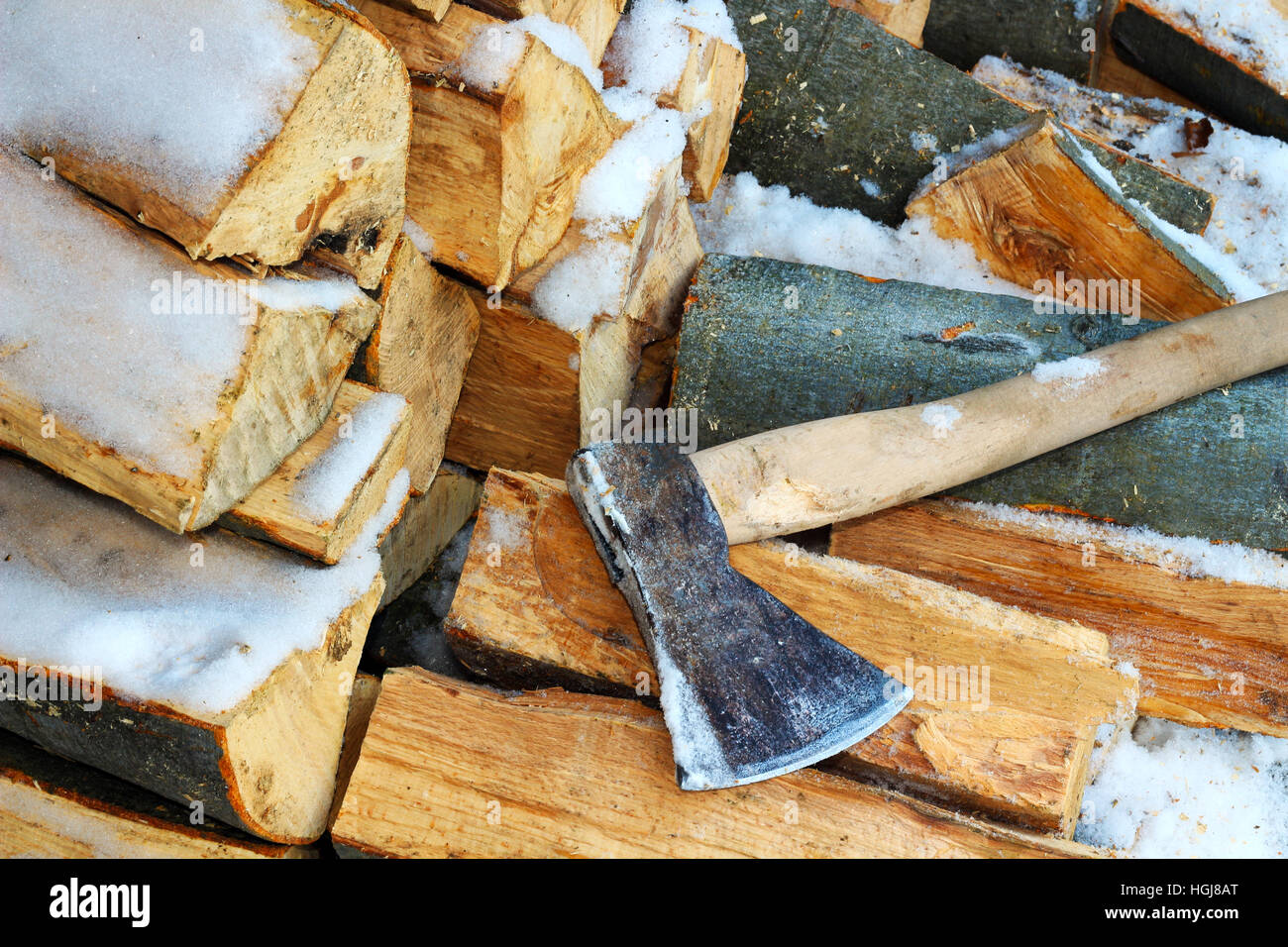 Stacked firewood in winter under the snow Stock Photo - Alamy