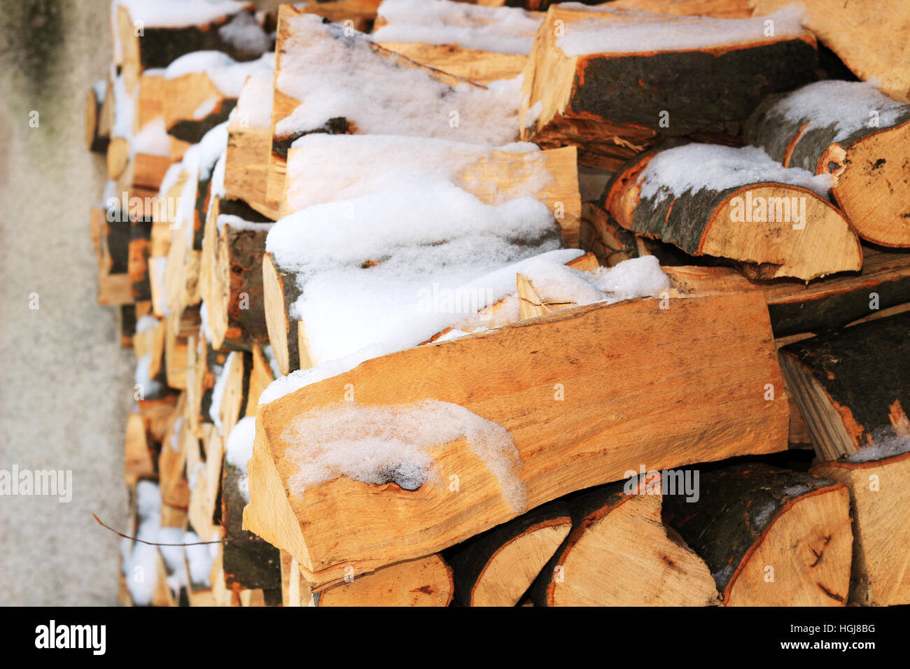 Stacked firewood in winter under the snow Stock Photo - Alamy