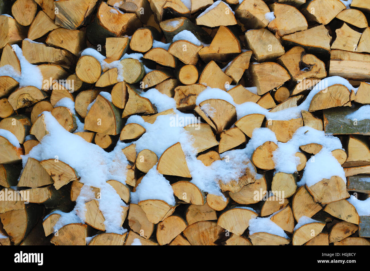 Stacked firewood in winter under the snow Stock Photo - Alamy