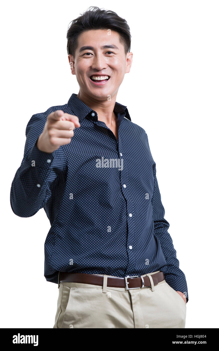 Happy young man pointing Stock Photo - Alamy