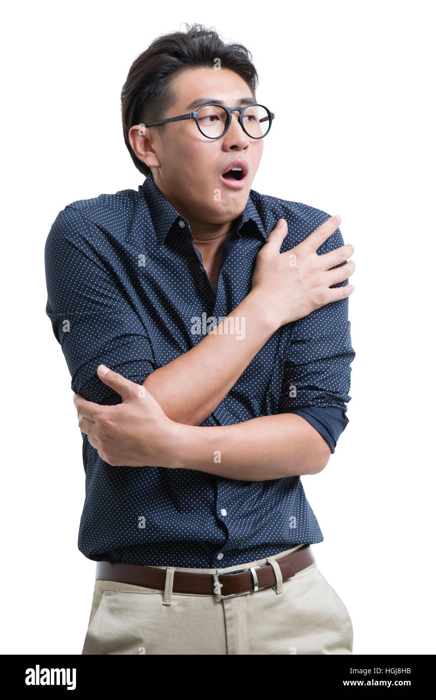 Young man feeling cold Stock Photo - Alamy