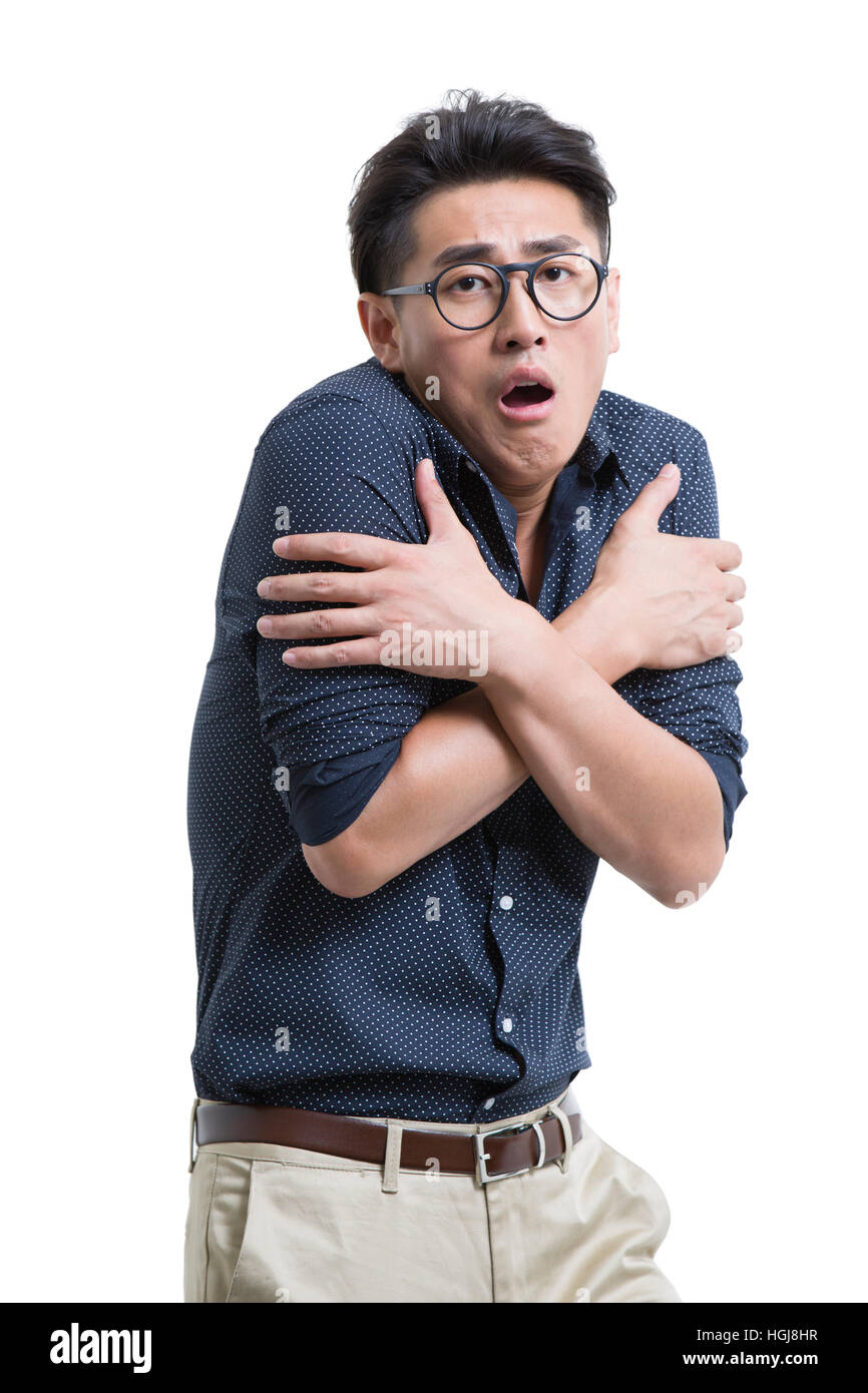Young man feeling cold Stock Photo - Alamy