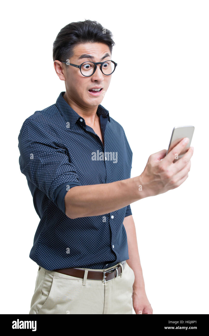 Shocked young man looking at smart phone Stock Photo - Alamy