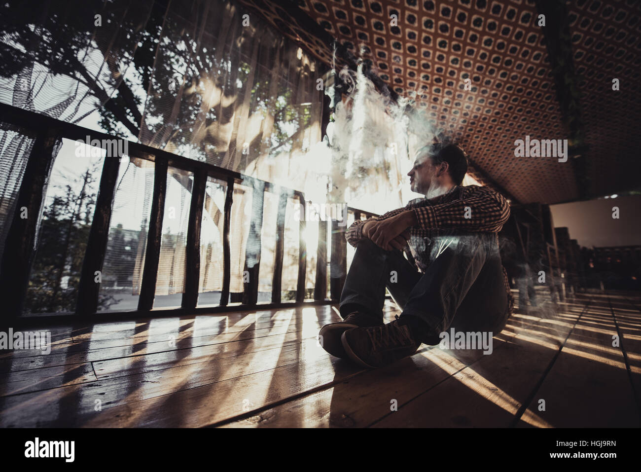 vaping young man produces vapor on sunset silhouette Stock Photo - Alamy