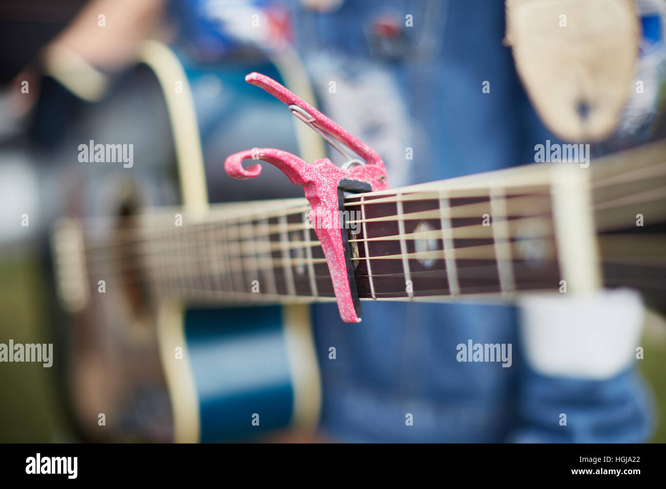 Acoustic guitar with capo on fifth fret. Blue acoustic guitar. Summer ...