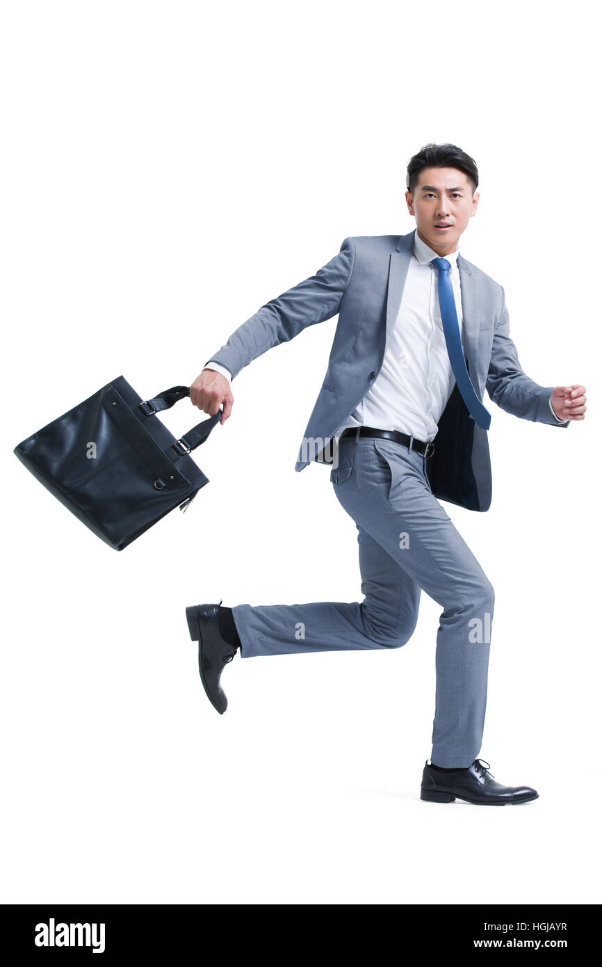 Young businessman running with briefcase Stock Photo - Alamy