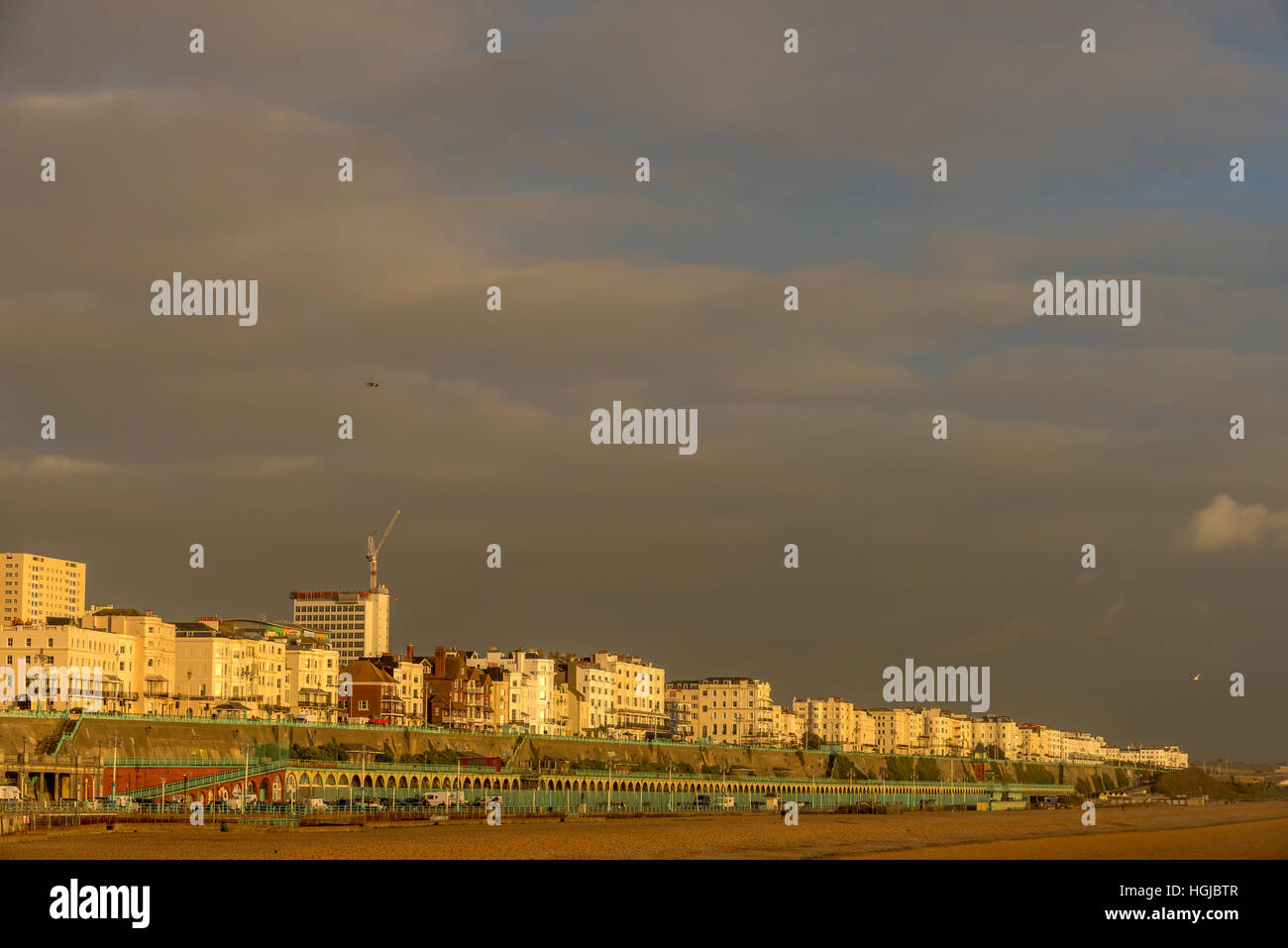 Golden light on the seafront at Brighton making the Regency buildings ...