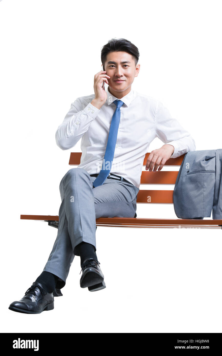 Confident young businessman talking on cell phone Stock Photo - Alamy
