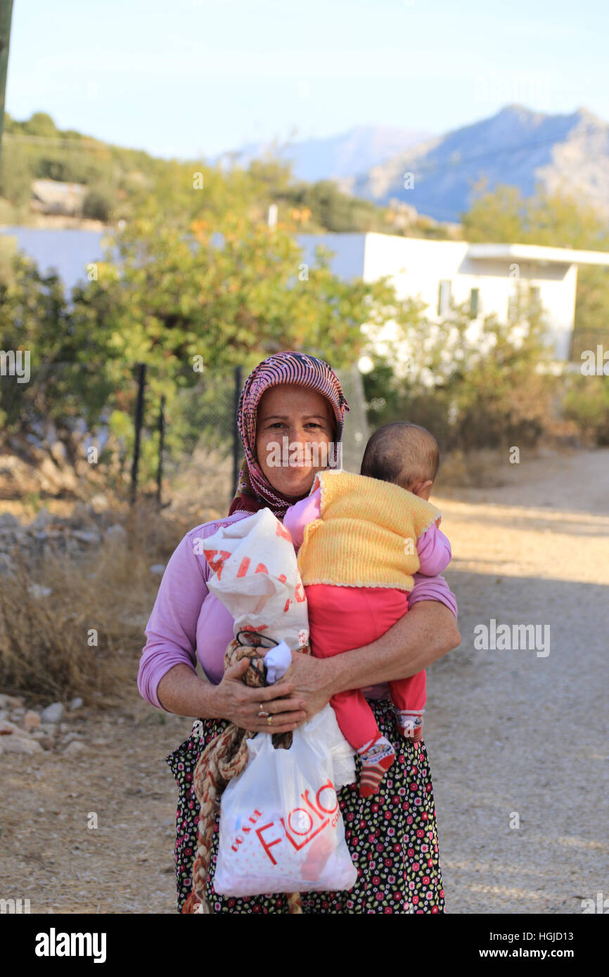 Traditional Turkish lady holding a baby Stock Photo - Alamy