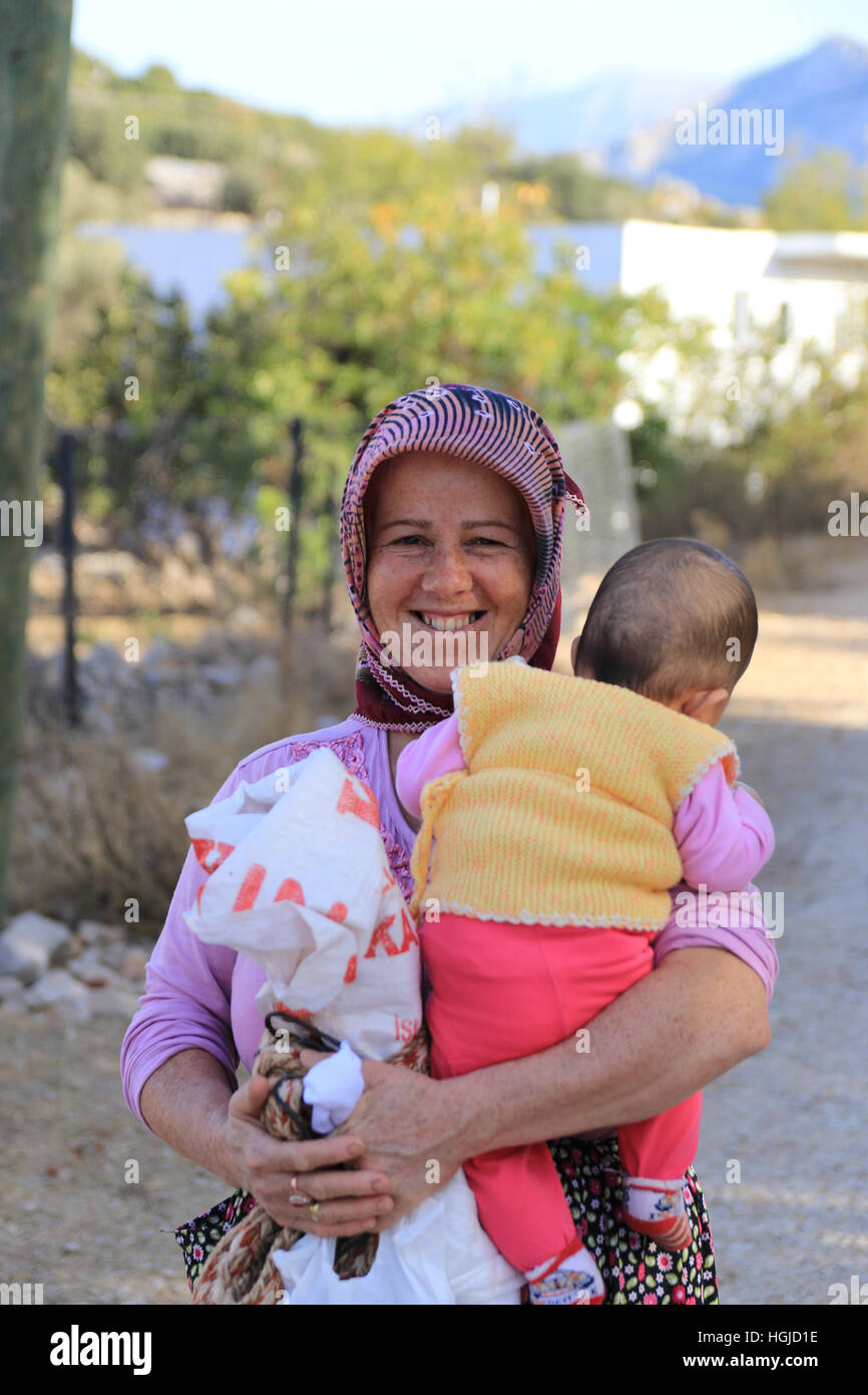 Traditional Turkish lady holding a baby Stock Photo - Alamy