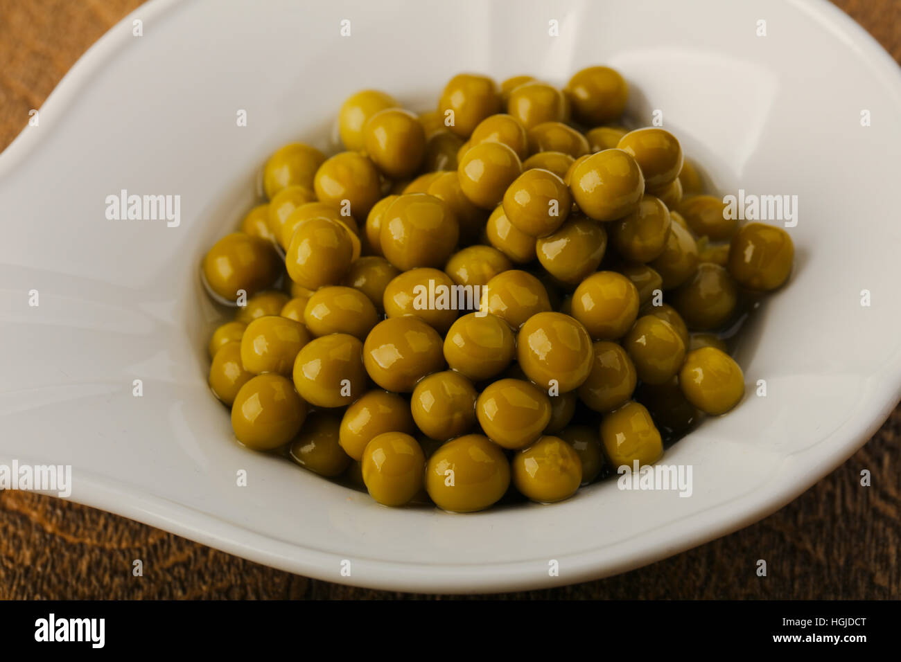 Pickled green pea on the wood background Stock Photo - Alamy