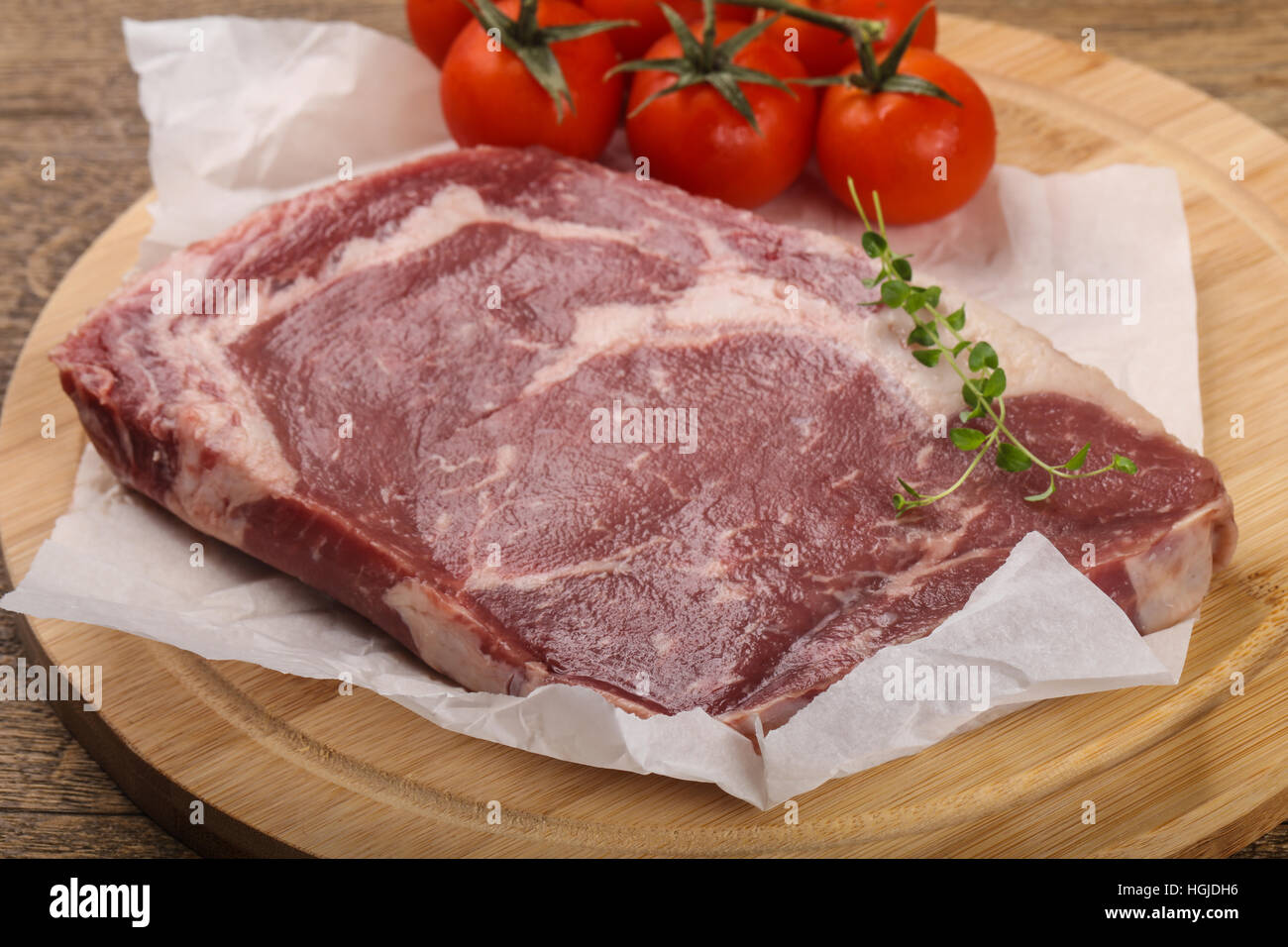 Raw ribeye steak with thyme - ready for cooking Stock Photo - Alamy