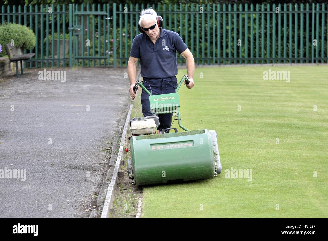 Motorised lawn mower and operator Stock Photo - Alamy