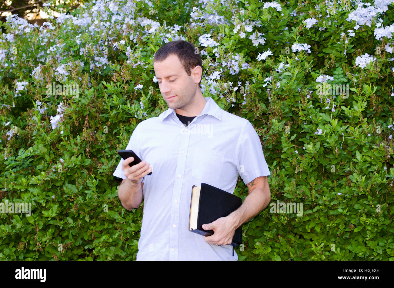 Smiling man holding bible hi-res stock photography and images - Alamy