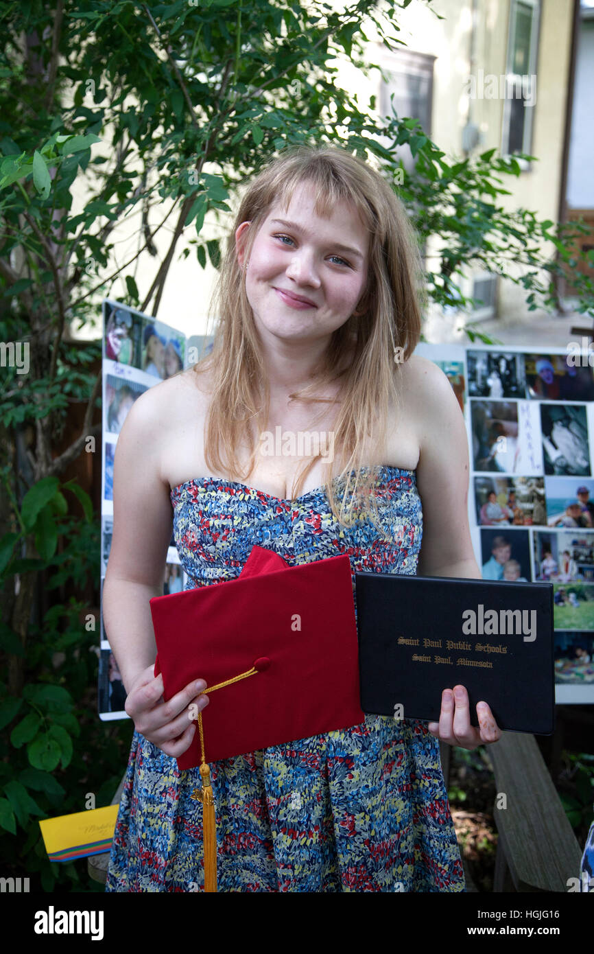 Happy teen woman, a recent high school graduate holding her diploma ...